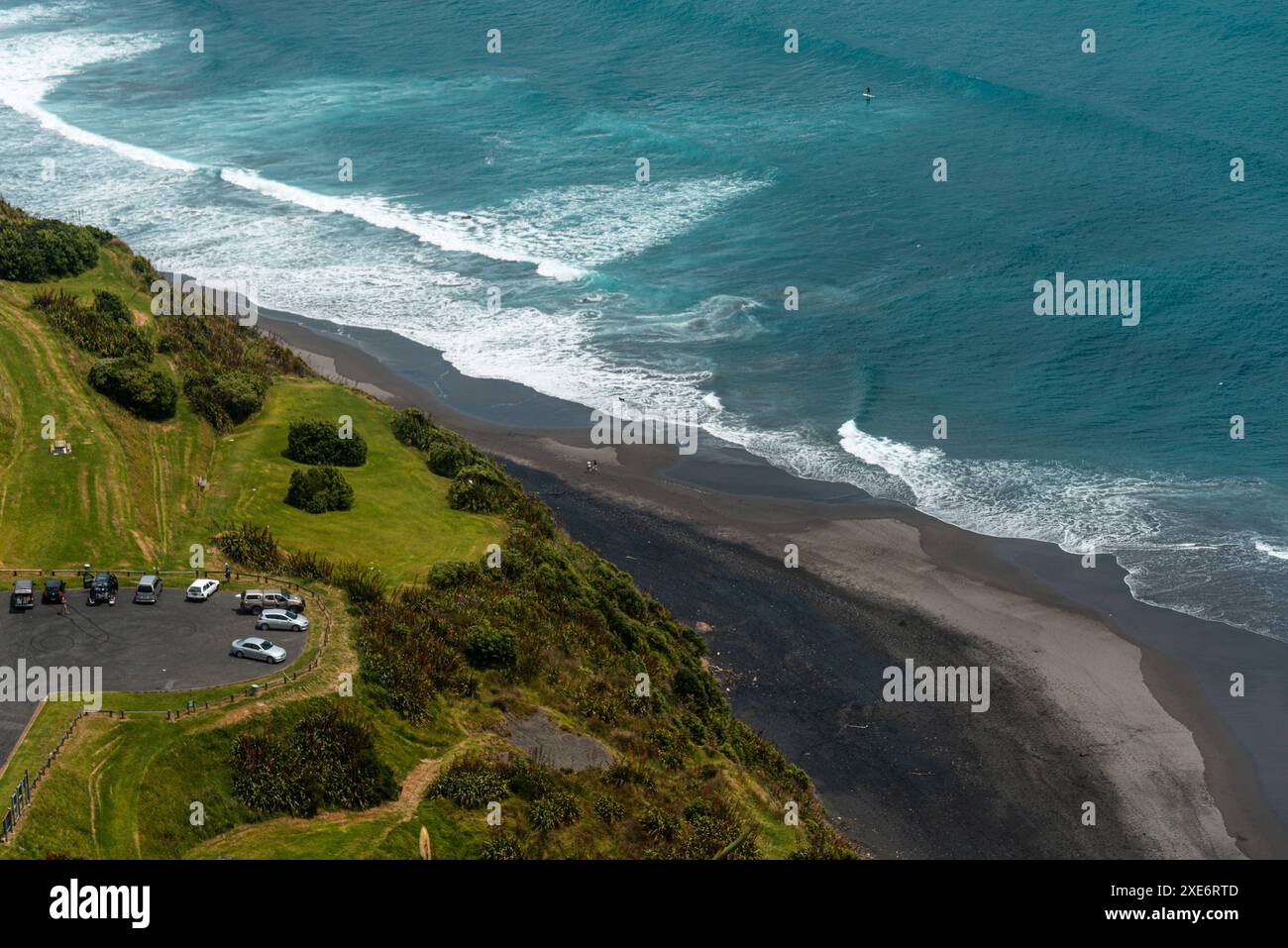 Aerial view along the blue coastline of the North Island with black ...