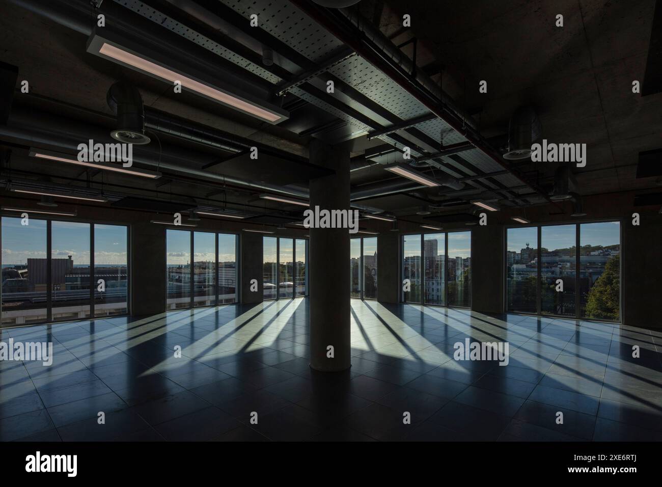 Strong shadows being cast by low sun in the top floor office floor ...