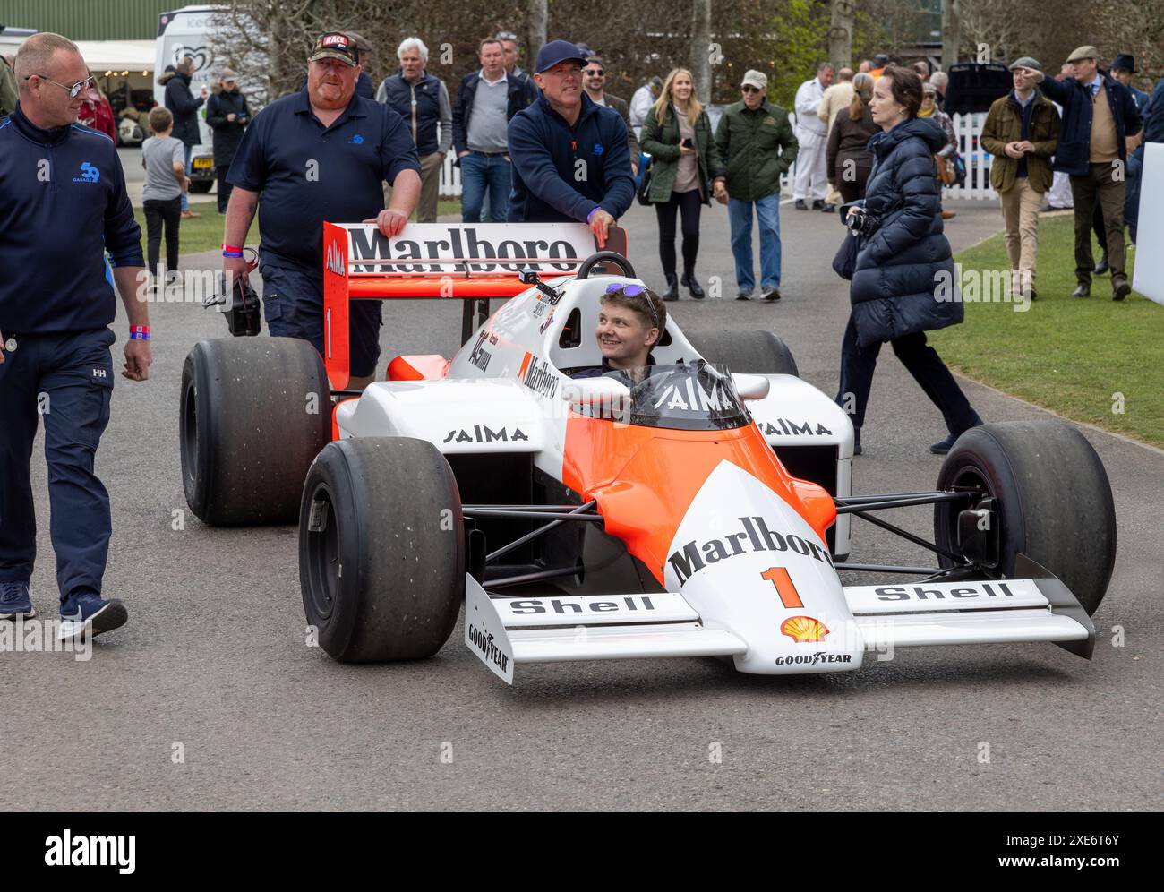Niki Lauda's 1985 McLaren MP4/2B rolls through the paddock to the ...