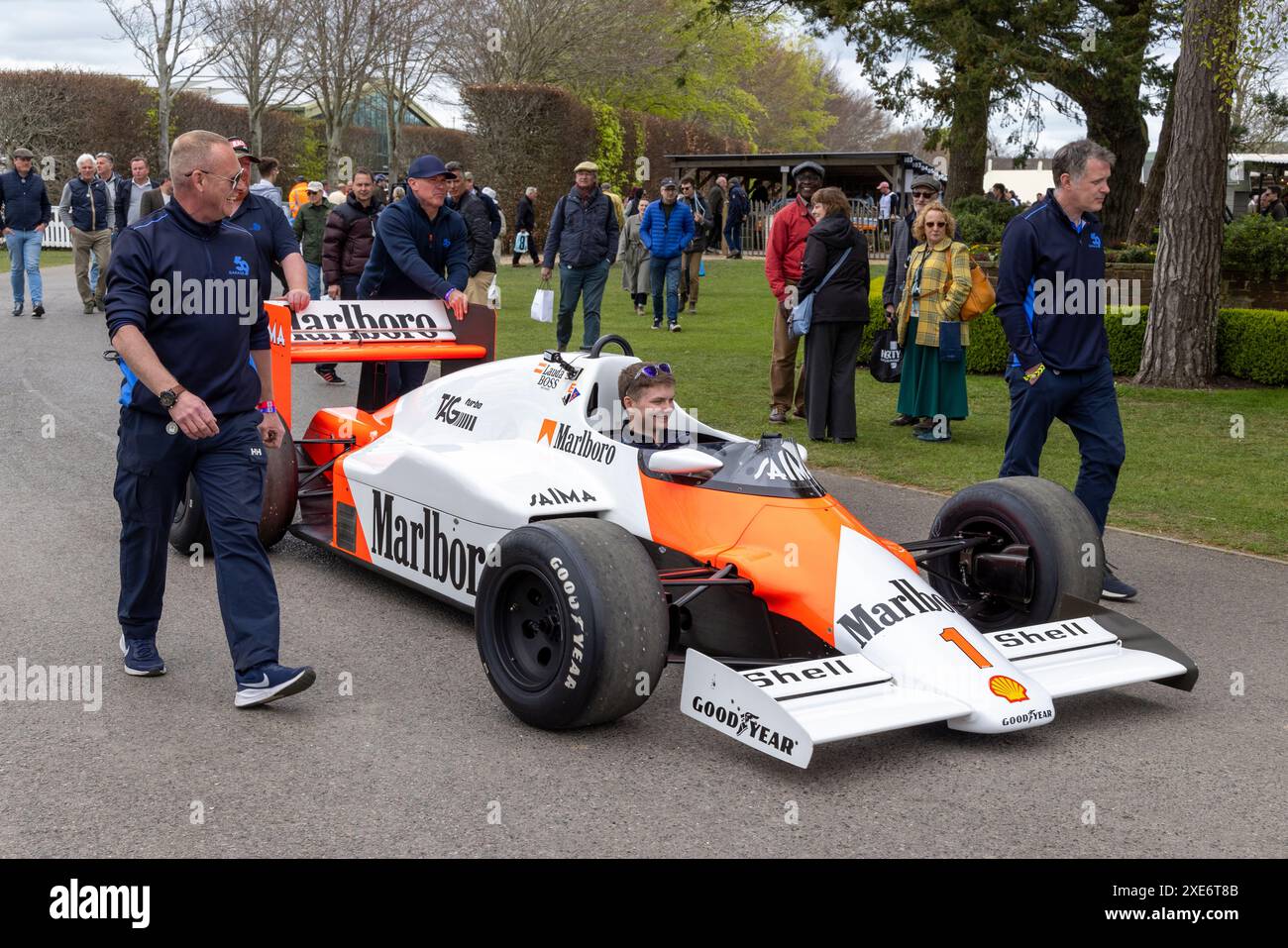 Niki Lauda's 1985 McLaren MP4/2B rolls through the paddock to the ...