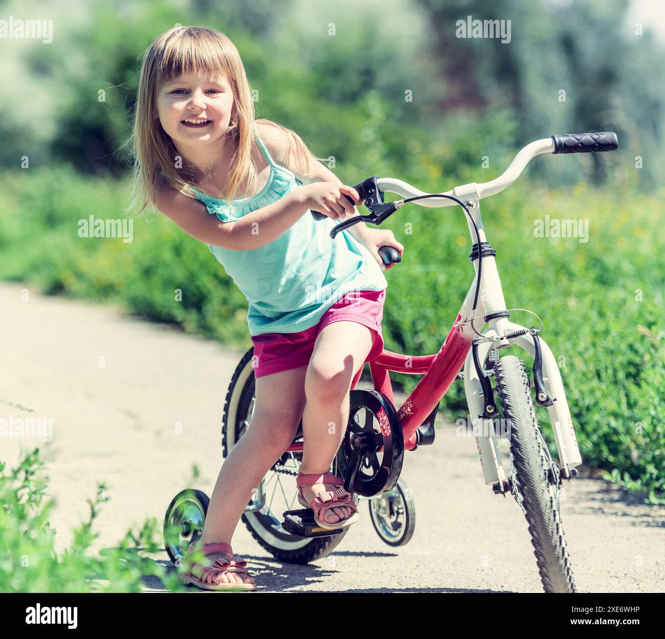 cute little girl on bicycle in green park Stock Photo - Alamy
