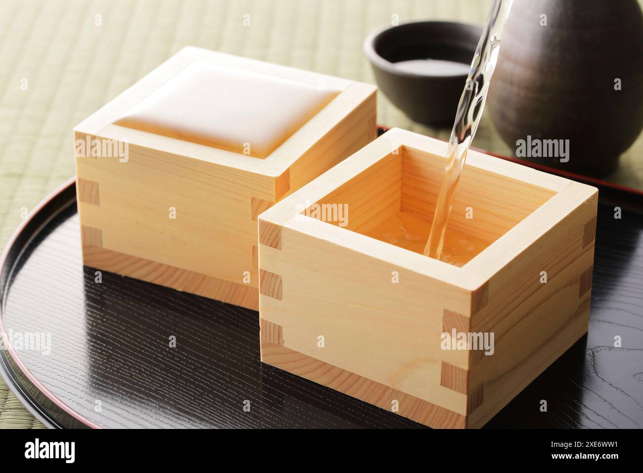 Sake poured into a square Stock Photo - Alamy