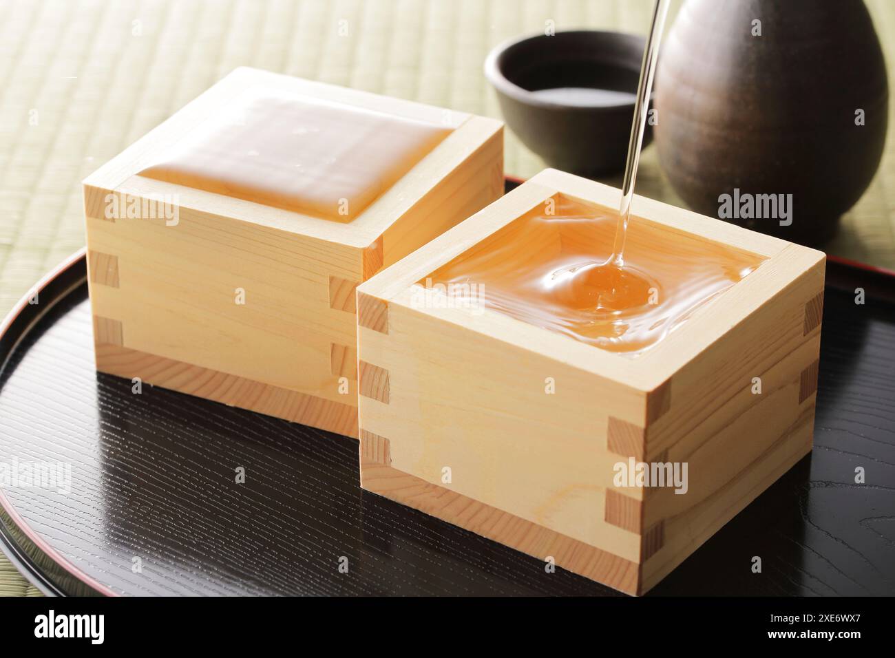 Sake poured into a square Stock Photo - Alamy