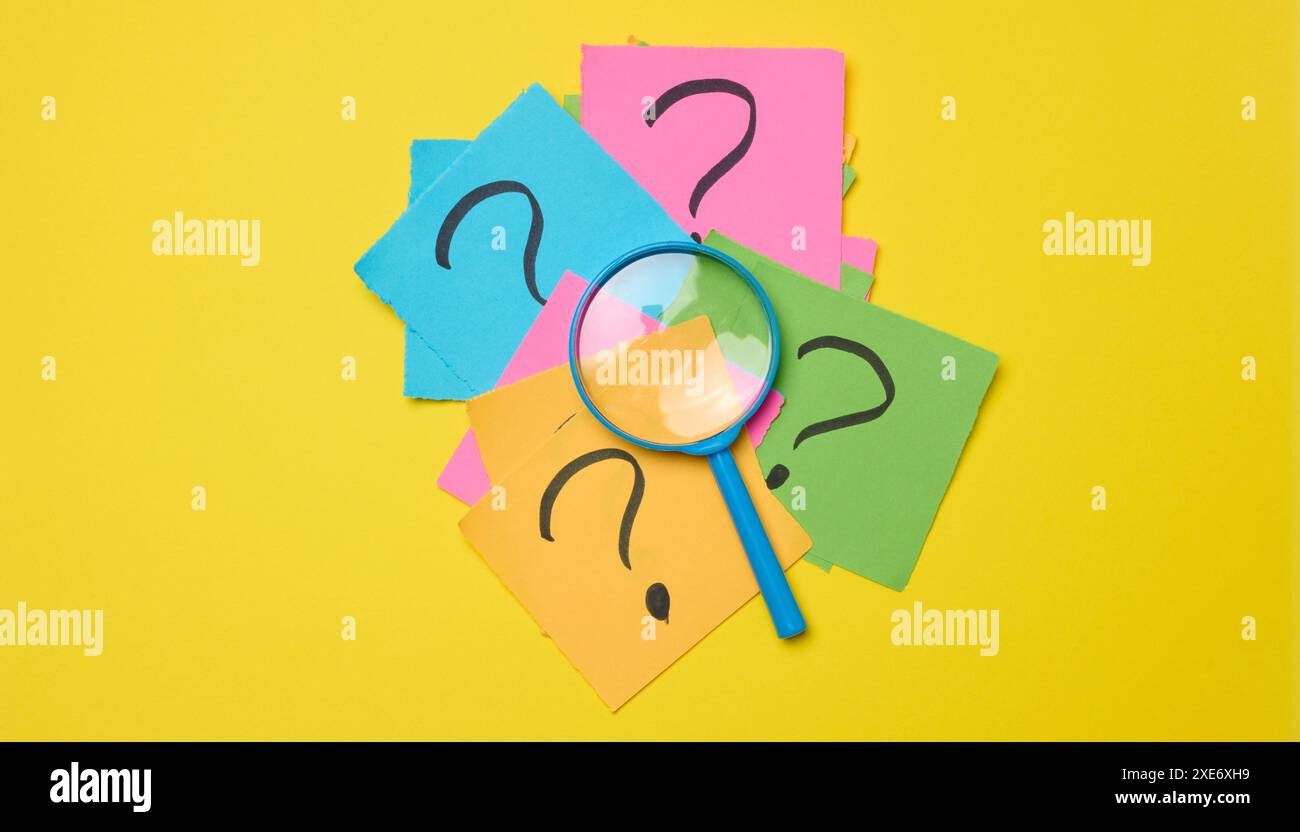 Drawn question marks on stickers and a magnifying glass, yellow ...