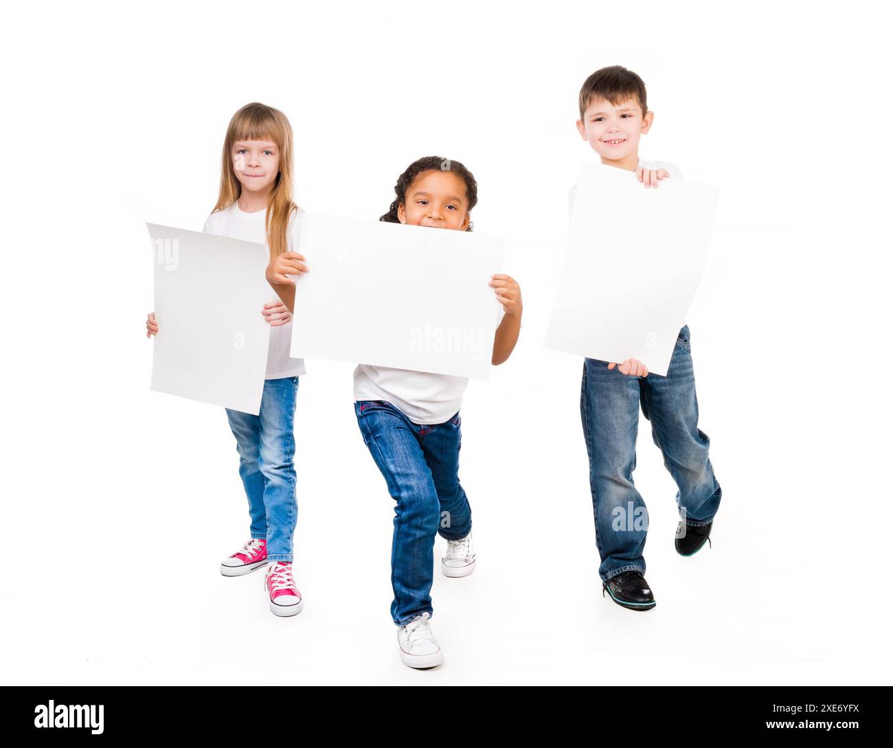 three funny children holding paper blanks in hands isolated on white ...
