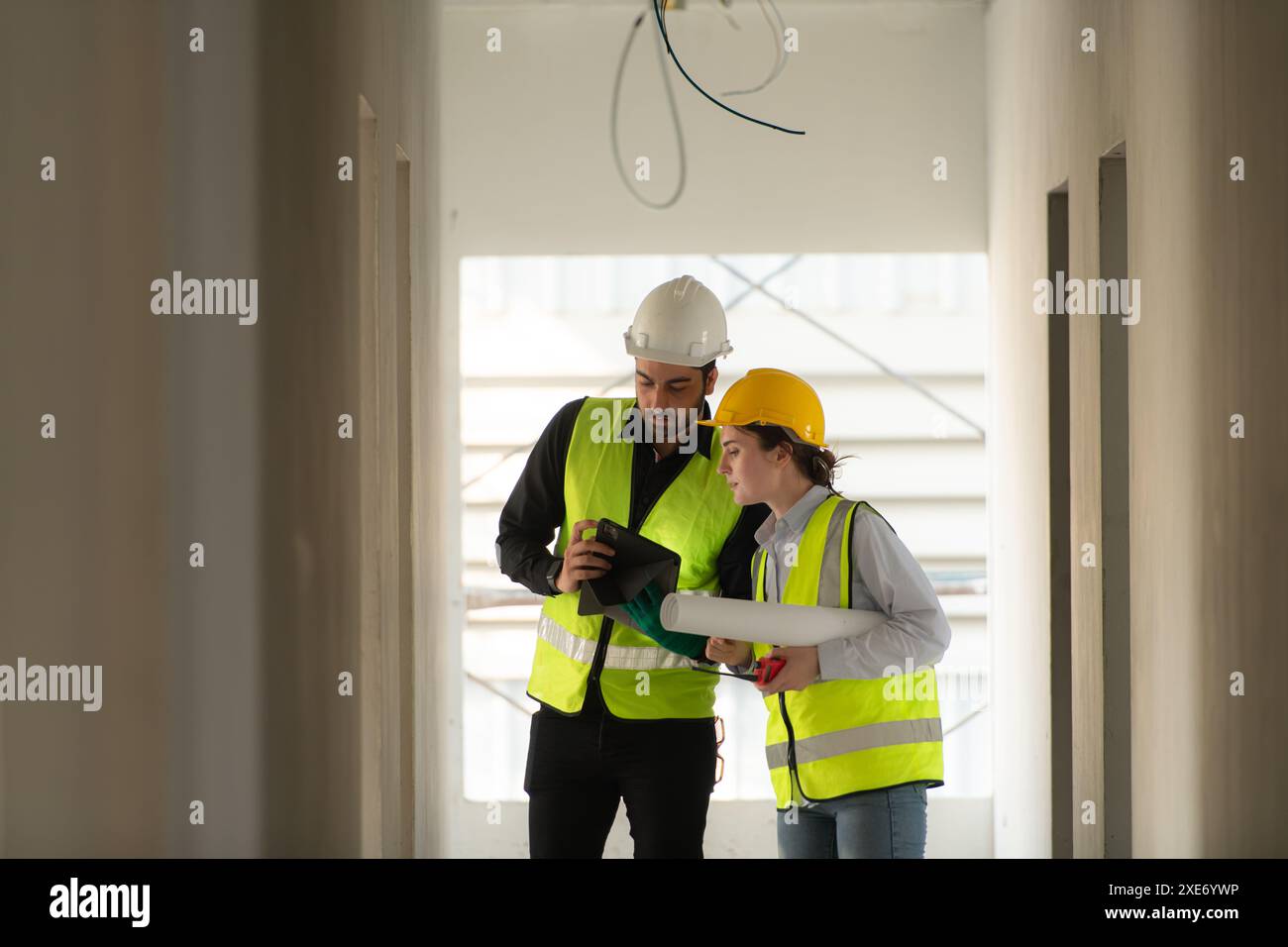 Engineer and architect working on the construction site, double ...