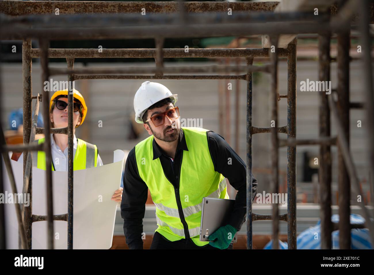 Engineer and architect working on the construction site, double ...