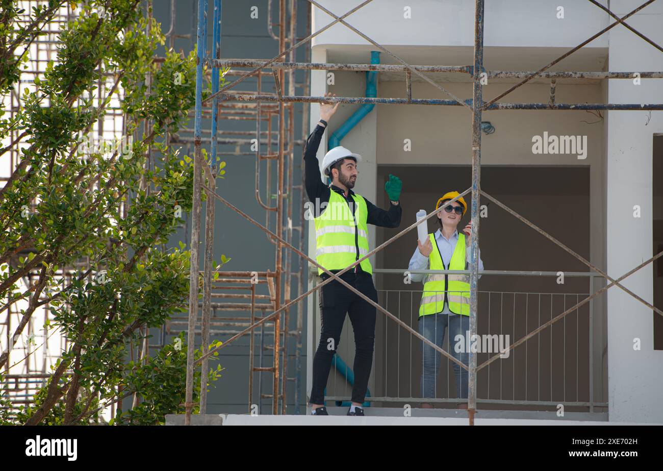 Engineer and architect working on the construction site, double ...