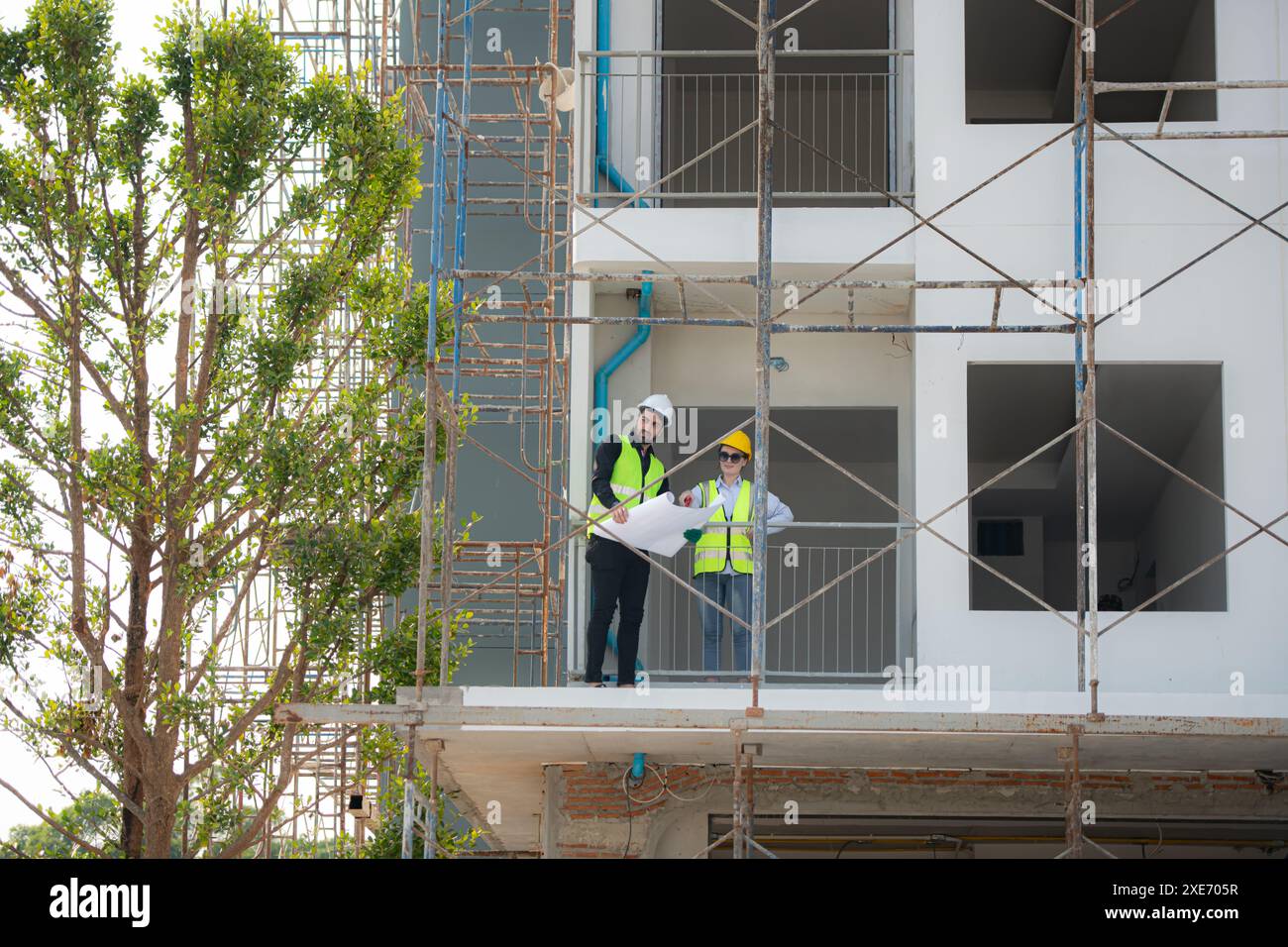 Engineer and architect working on the construction site, double ...