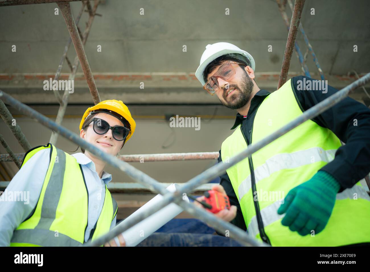 Engineer and architect working on the construction site, double ...