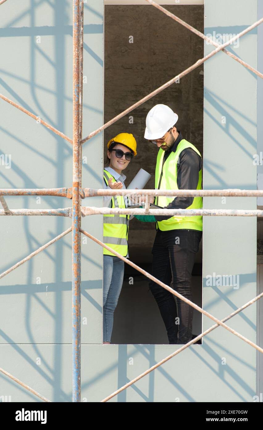 Engineer and architect working on the construction site, double ...