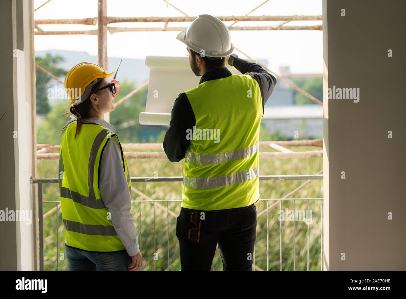 Engineer and architect working on the construction site, double ...