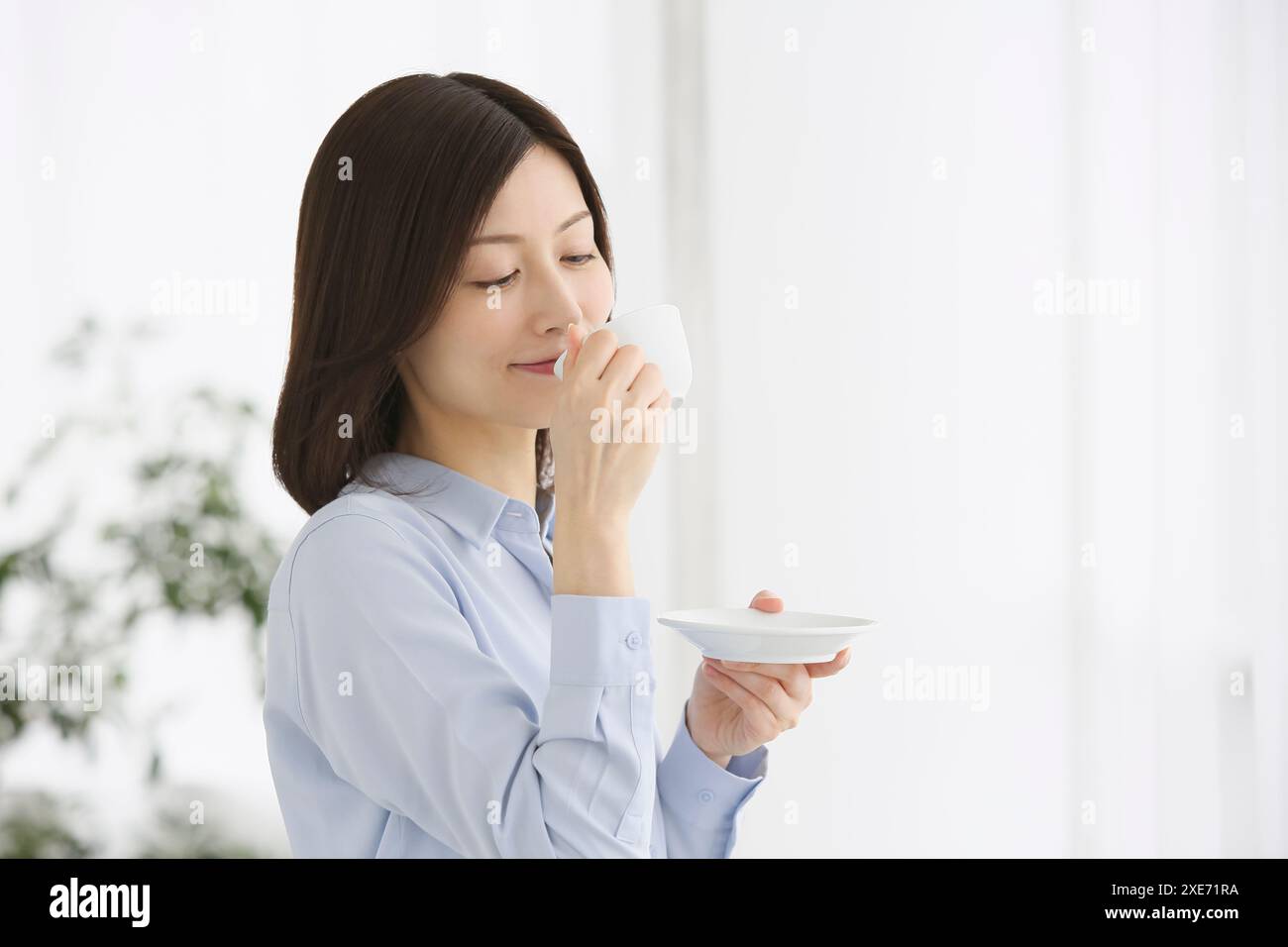 Woman having a coffee break Stock Photo - Alamy
