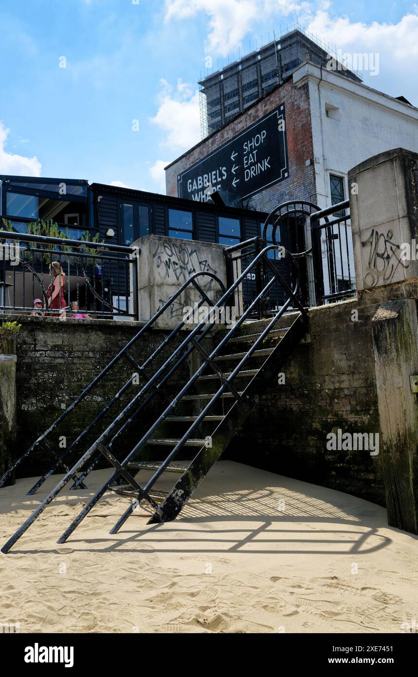 Staircase from the beach on the River Thames up to the bars and ...