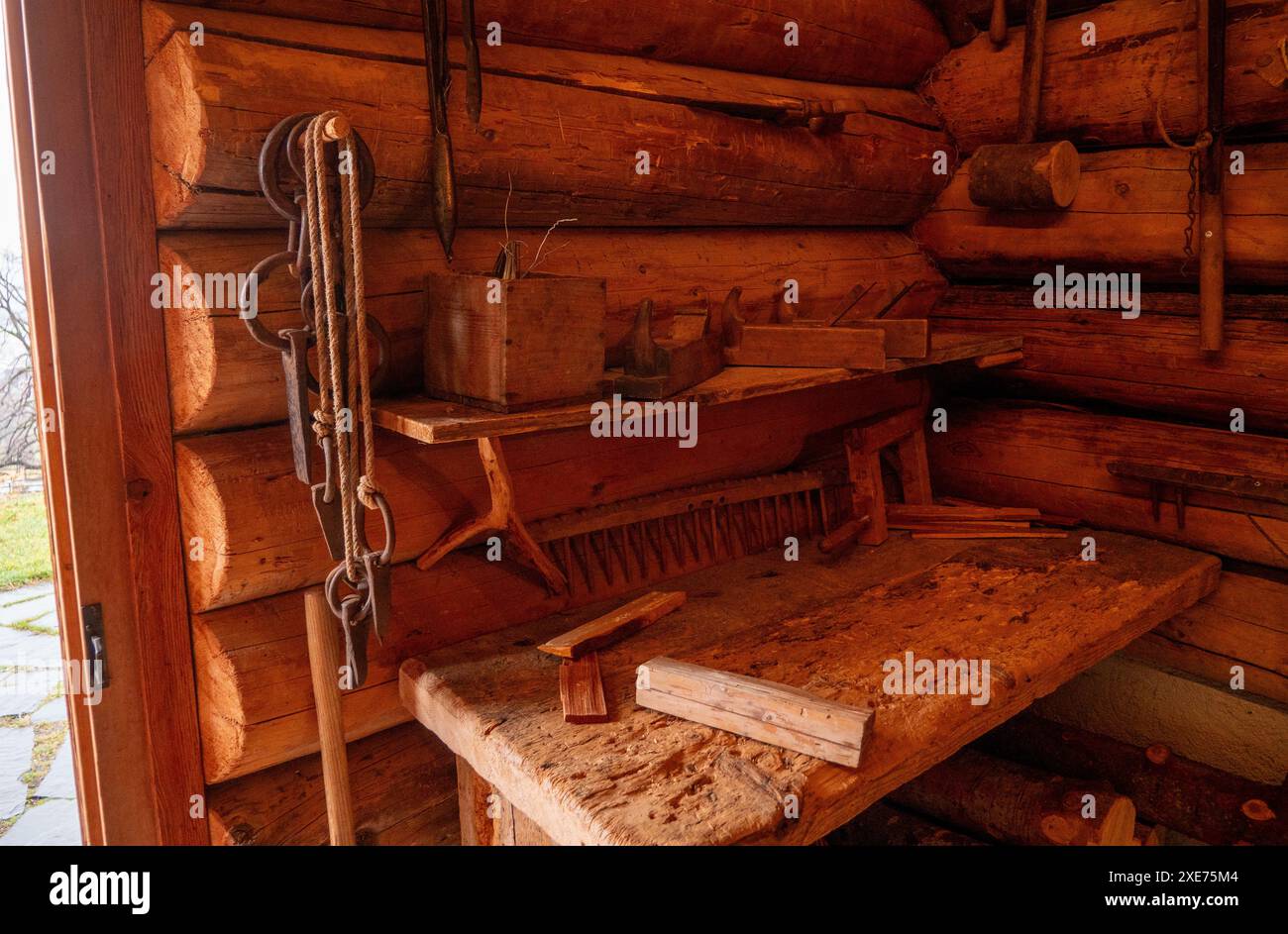 A rustic wooden workshop with various tools and equipment inside a log ...