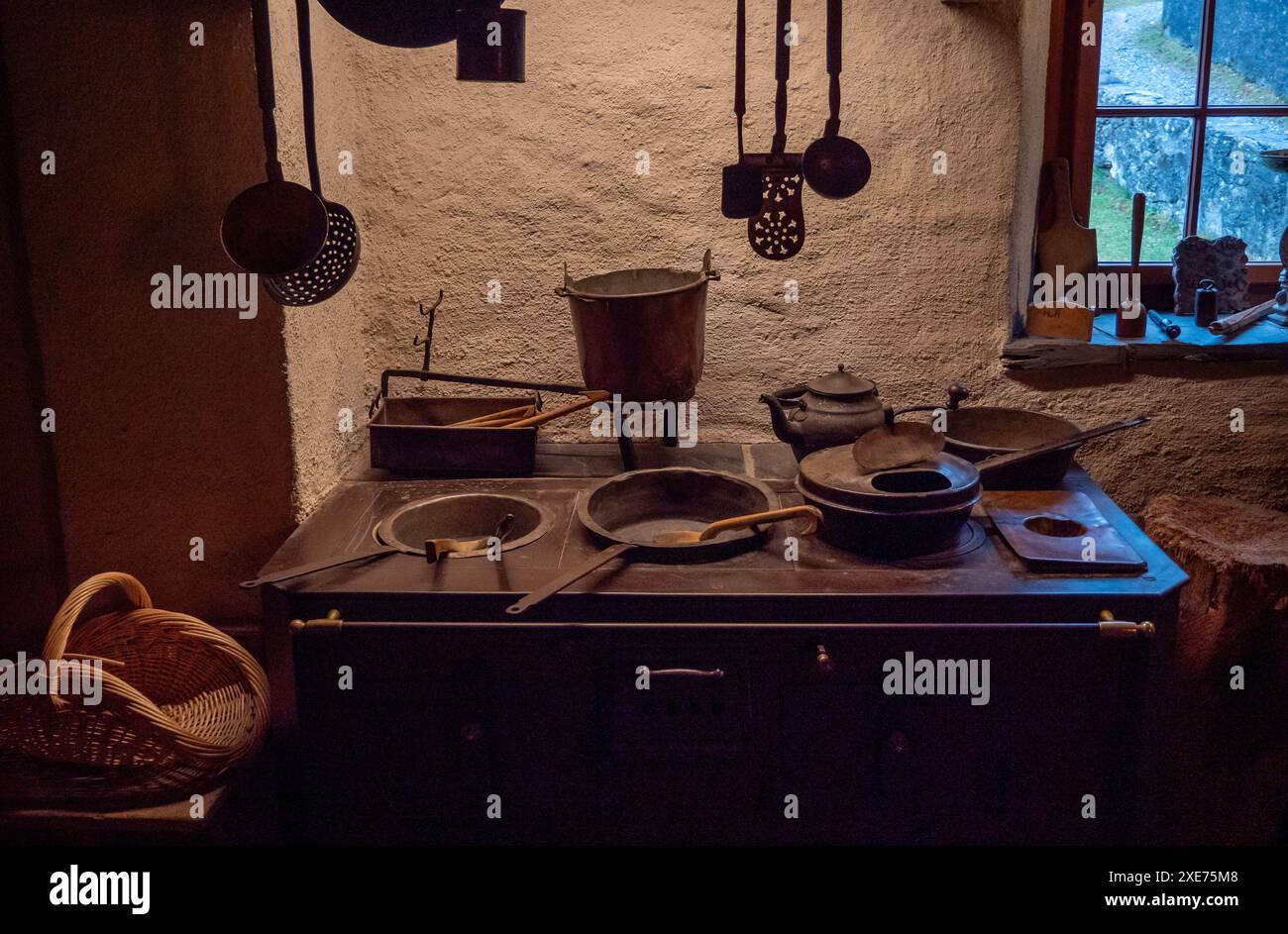 Vintage kitchen with old-fashioned cooking utensils and stove by a ...