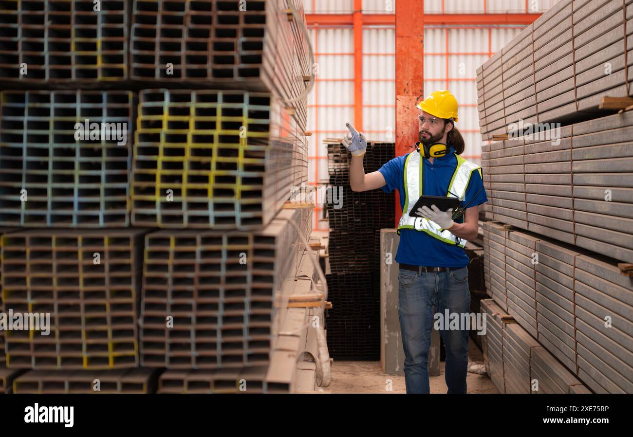 Warehouse worker in hard hats and helmets stand in the warehouse to ...