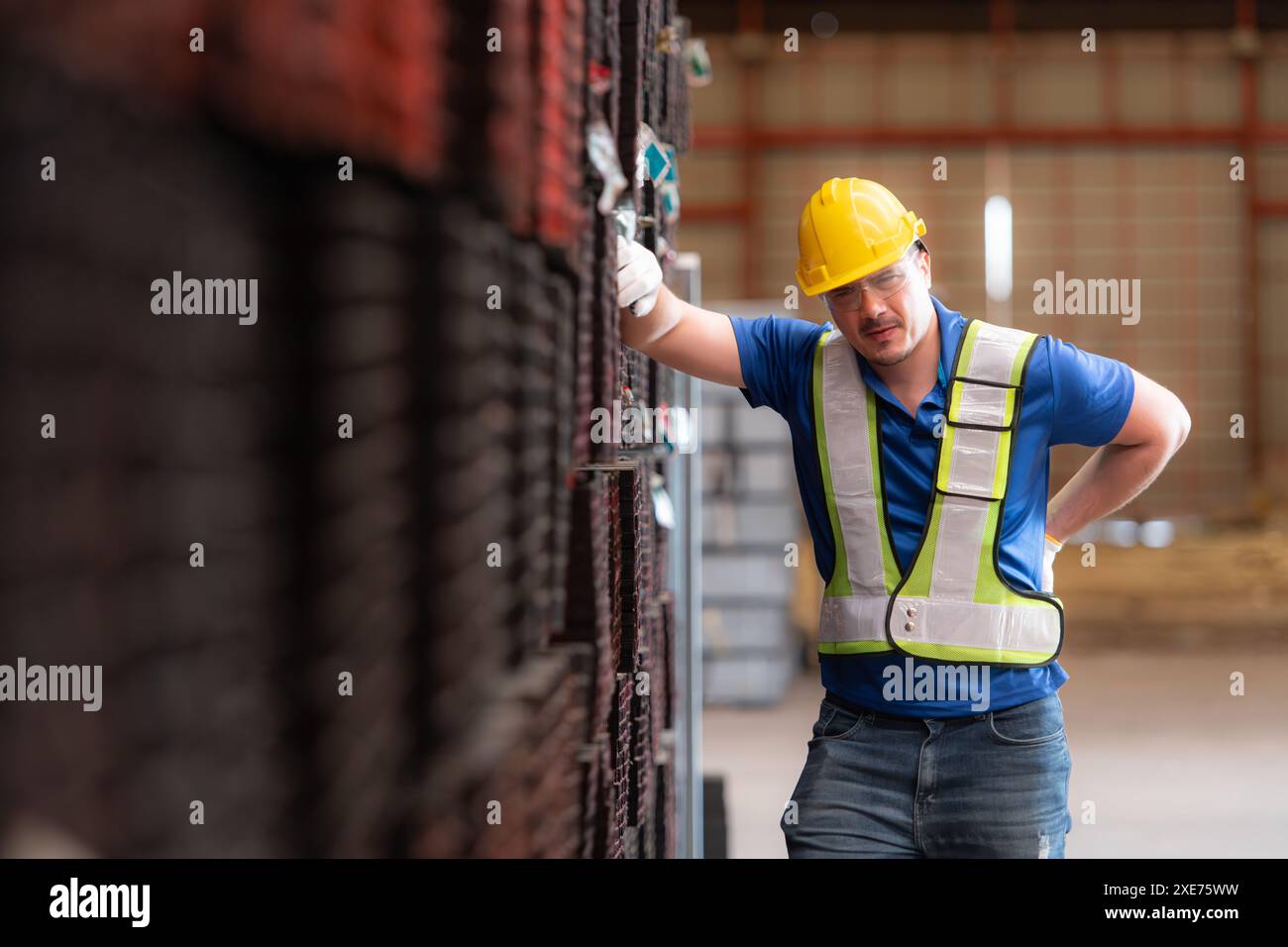 Portrait of a male worker wearing a safety vest and helmet standing on ...