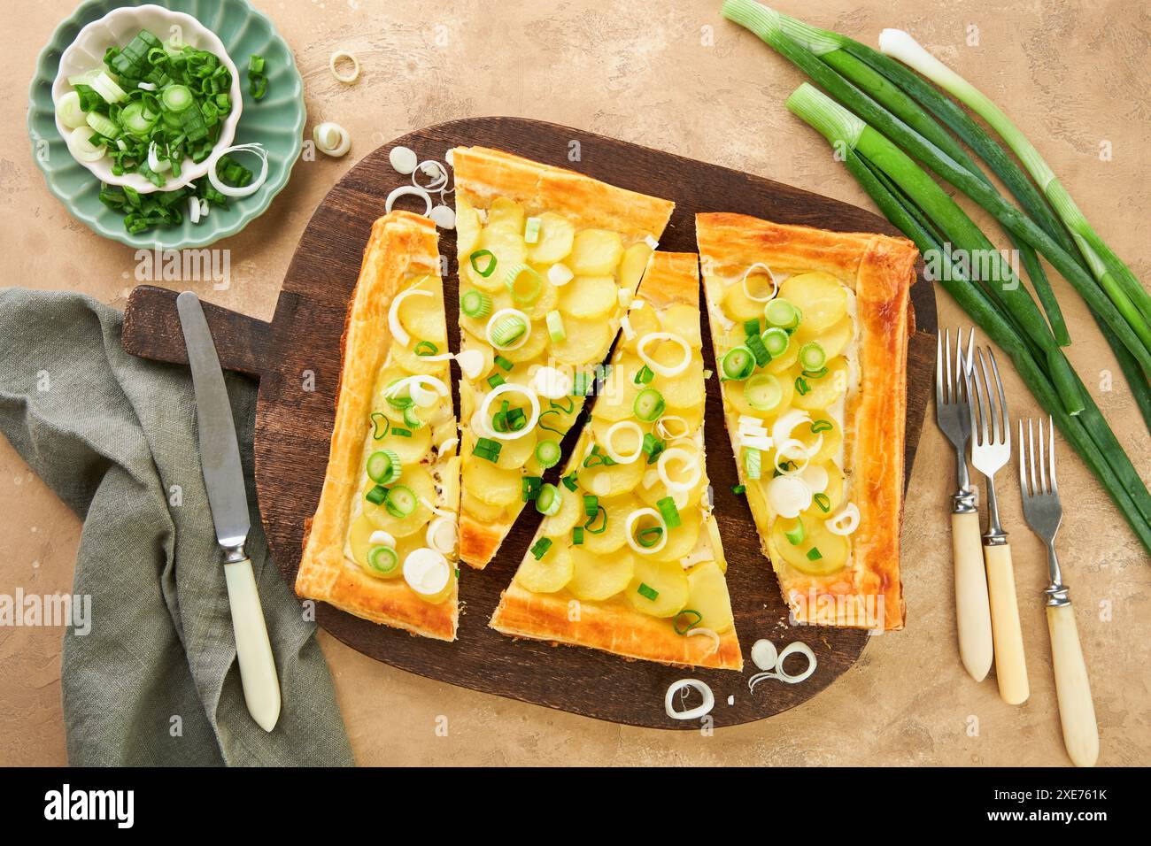 Homemade puff pastry tart or galette with potatoes, cream cheese and ...