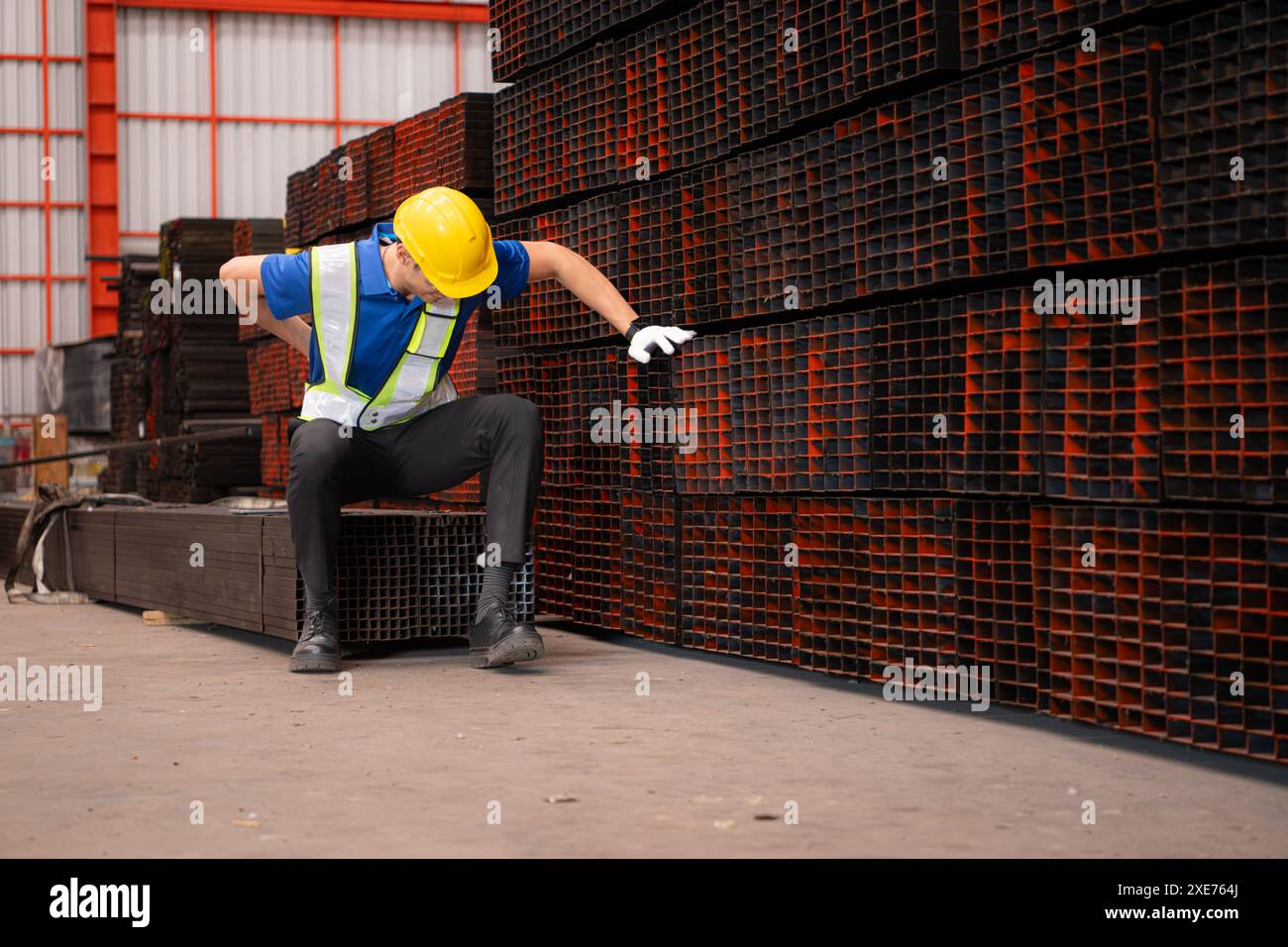 Portrait of a male worker wearing a safety vest and helmet sitting on a ...