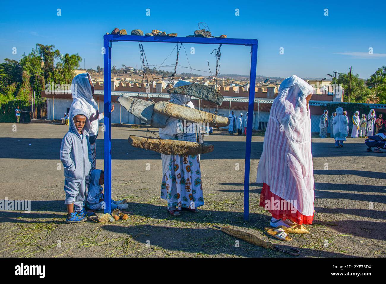 Pilgrims at an old stone bell at the Coptic Cathedral of St. Mariam ...