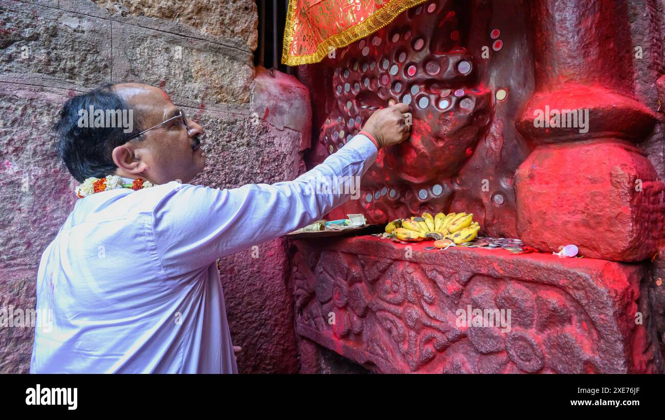 Male devotee with coin offering, Kamakhya Temple, Guwahati, Assam ...
