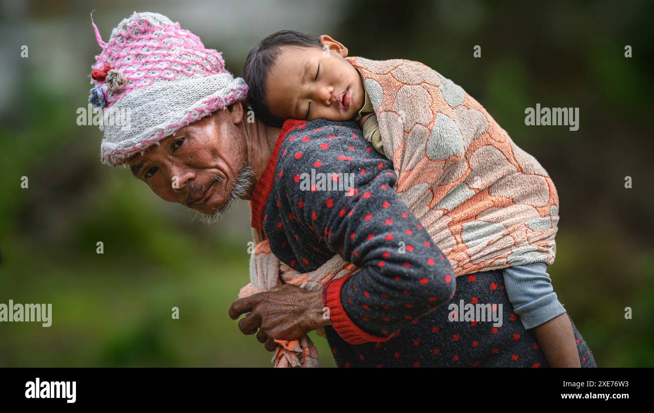 Nyishi Tribe, man carrying sleeping child on his back, Ziro Valley ...
