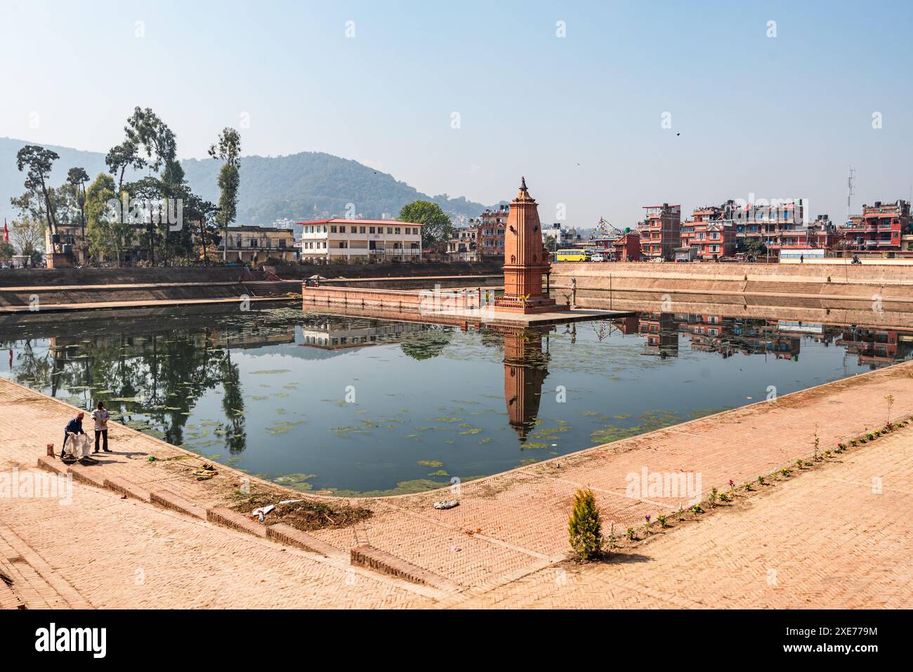 Bhajya Pukhu water basin with an ancient tower in the middle of ...