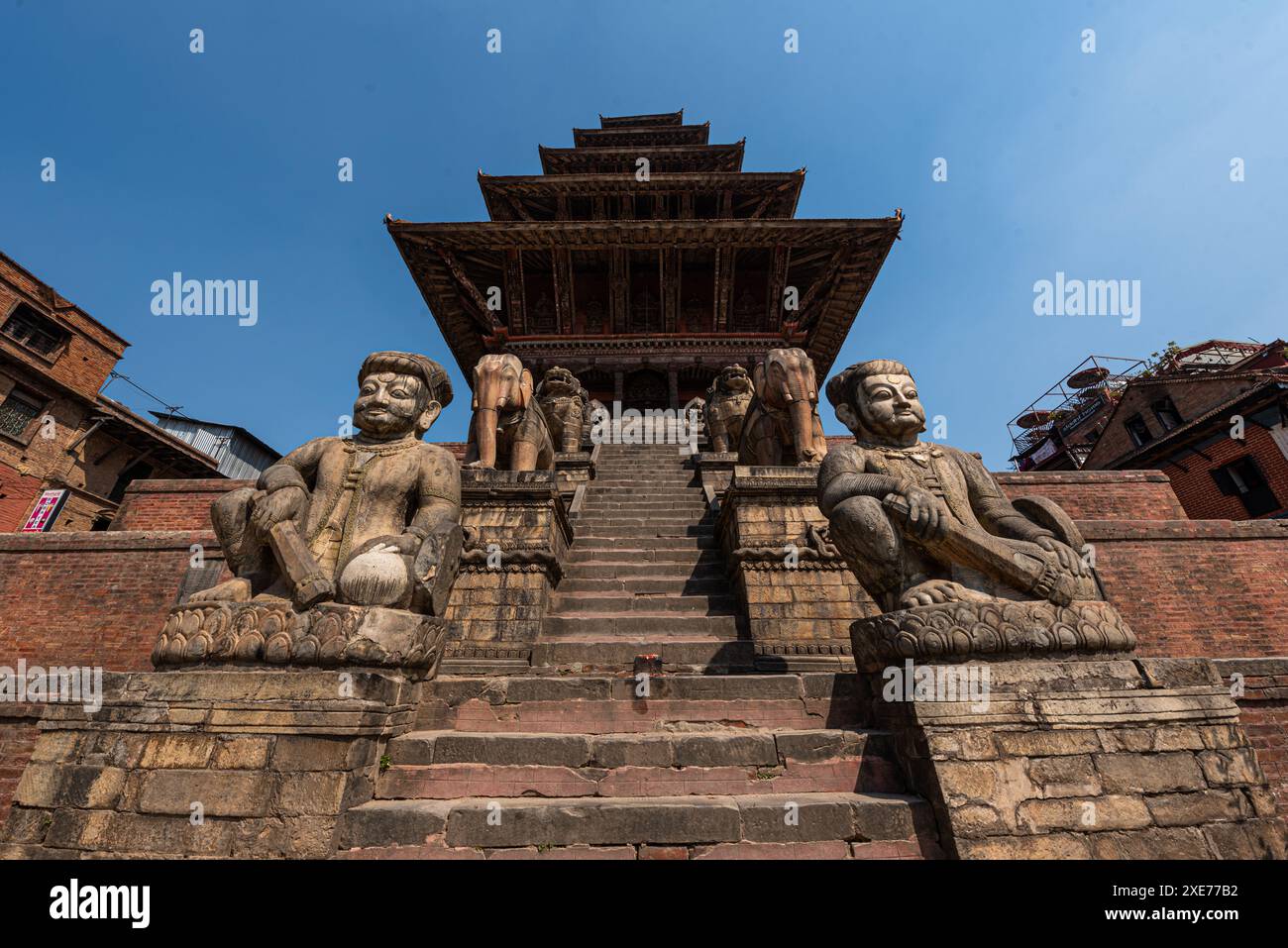 Stone steps and guarding statues at the main pagoda of Nyatapola Temple ...