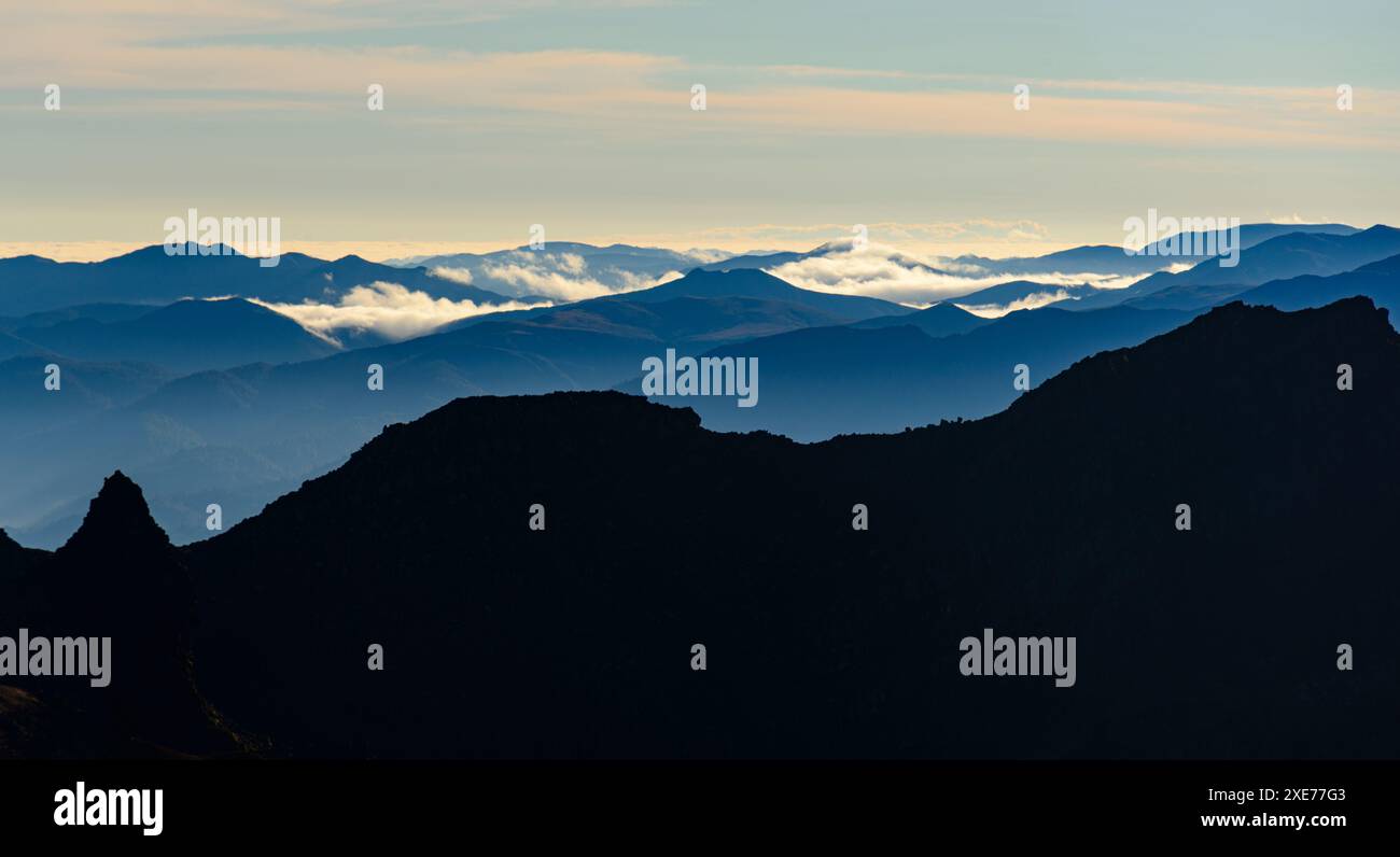 Silhouette volcanic landscape in front of blue mountain slopes, North ...