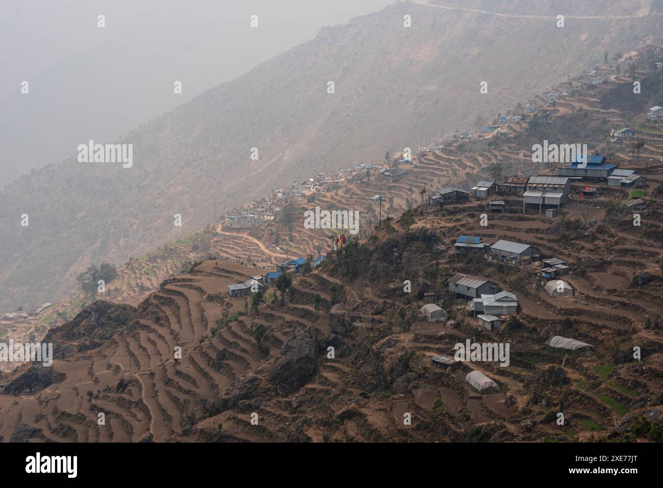 Himalayan village with farm houses spread across the endless terraces ...
