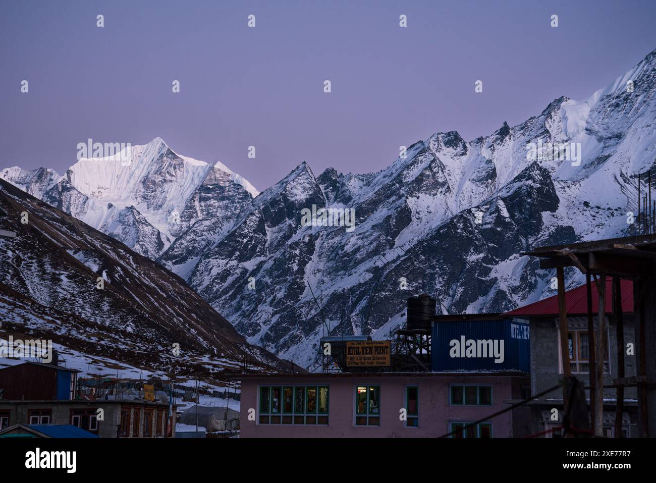 View over Kyanjin Gompa town with soft purple light after sunset and ...