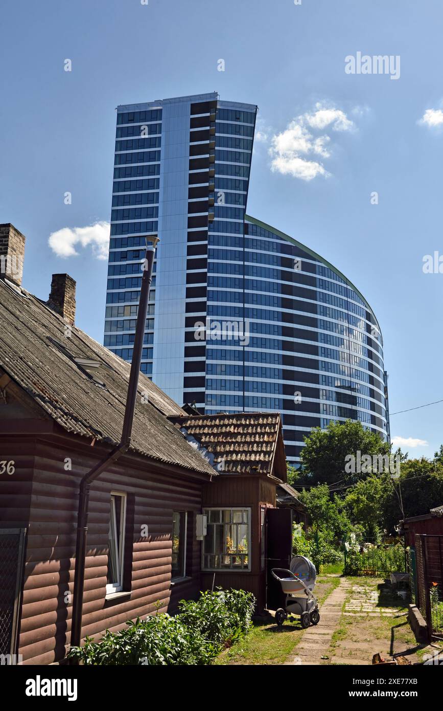 Old wooden houses surrounded by modern office towers in the Snipiskes ...