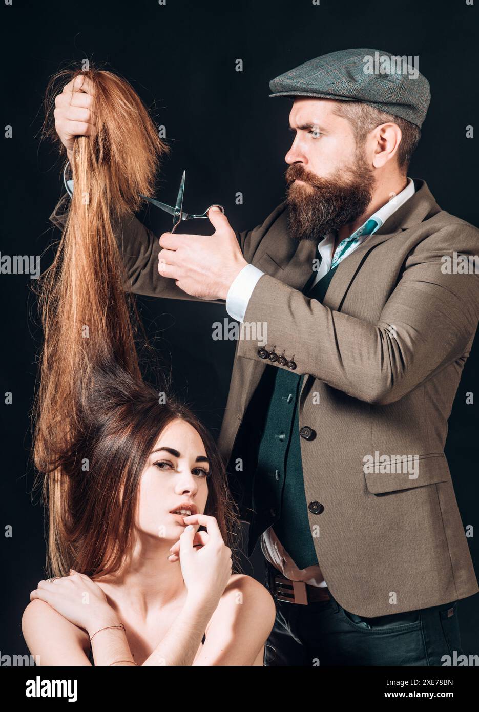Bearded Hairdresser make fashion hairstail. Beautiful model with very ...