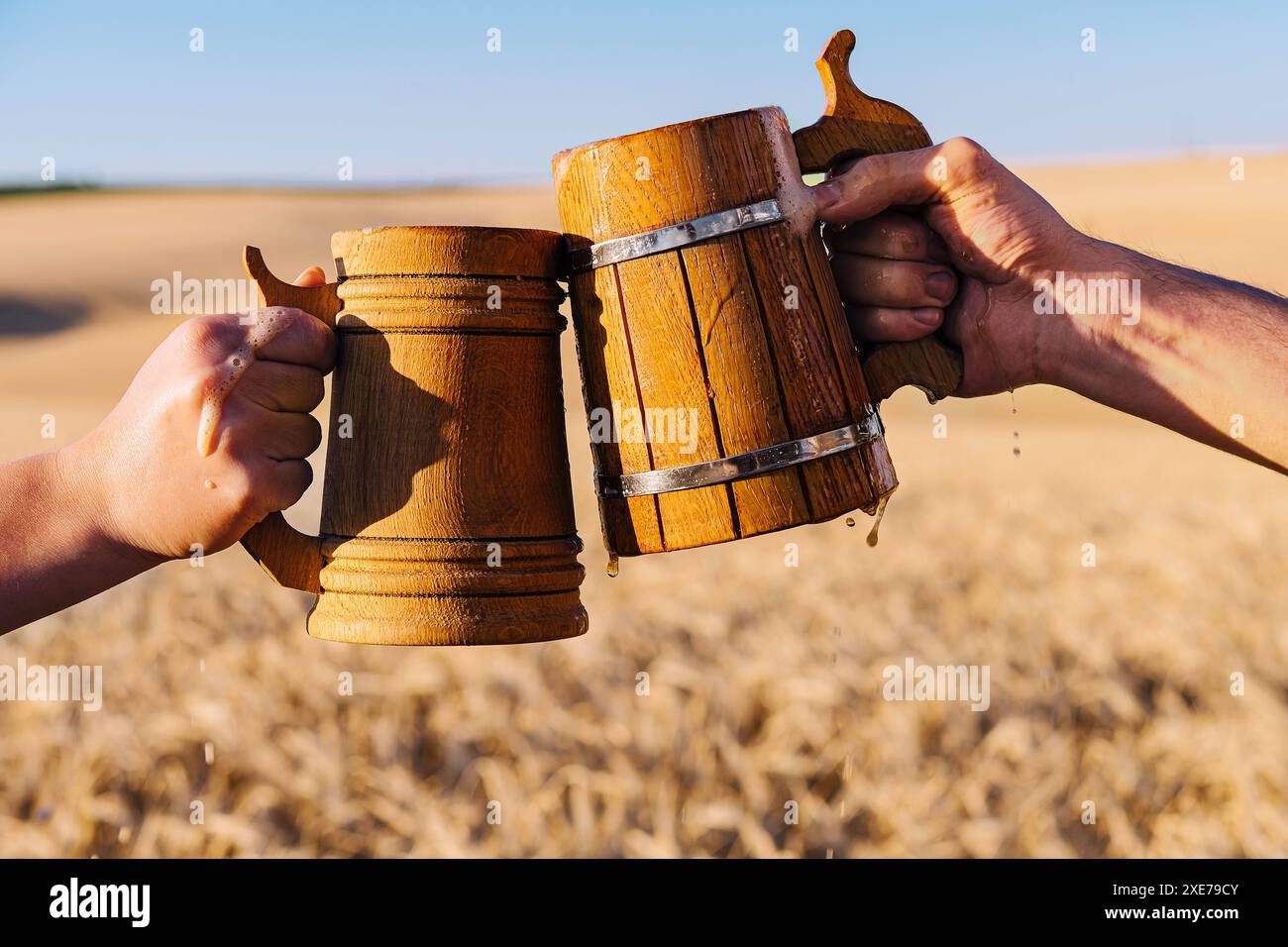 Hands wooden beer clink hi-res stock photography and images - Alamy