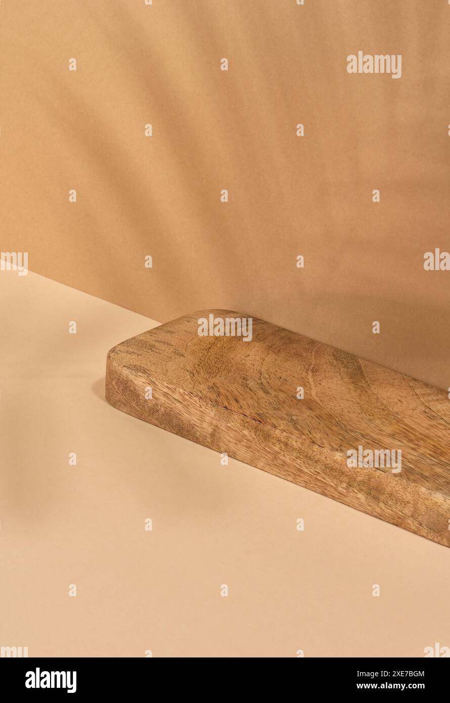 Wooden platform, shadow from a palm leaf on a brown background. Place ...