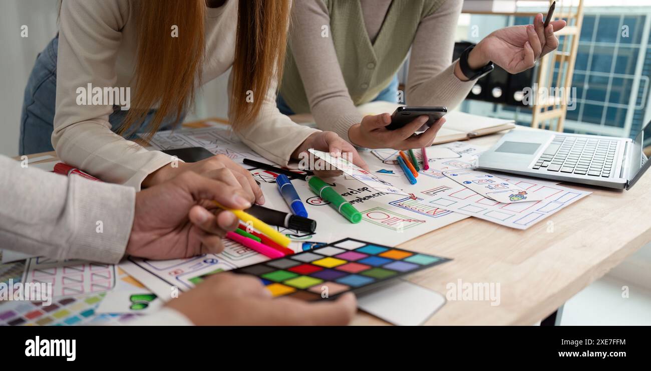 Creative Ux Developer And Ui Designer Brainstorming Session With Color Palettes And Wireframes