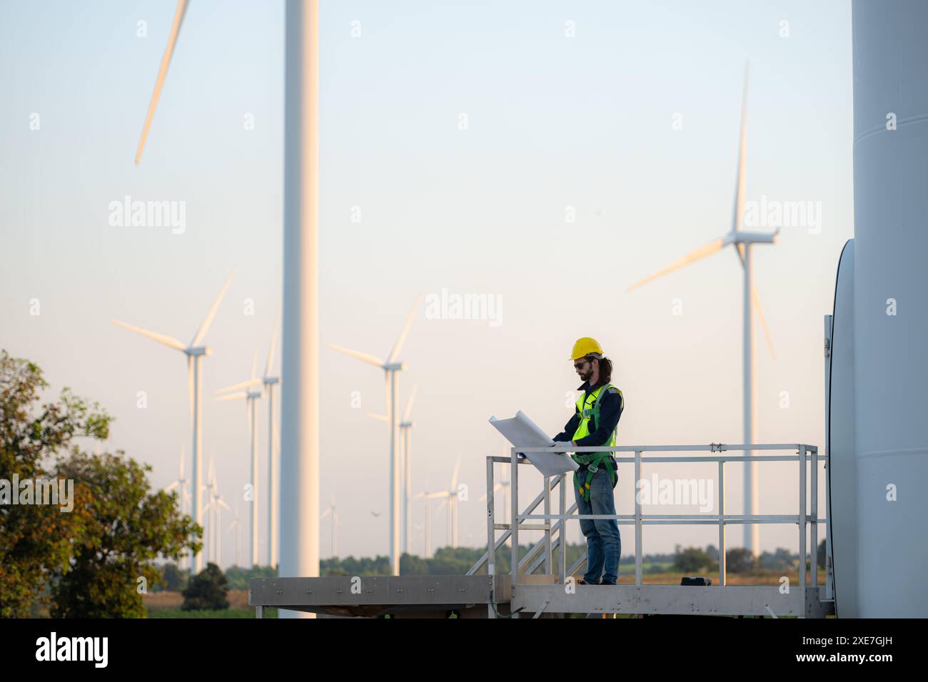 Engineer at natural energy wind turbine site with a mission to climb up ...