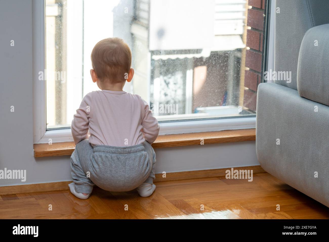 Toddler by the window, waiting for daddy. Concept of patience and ...