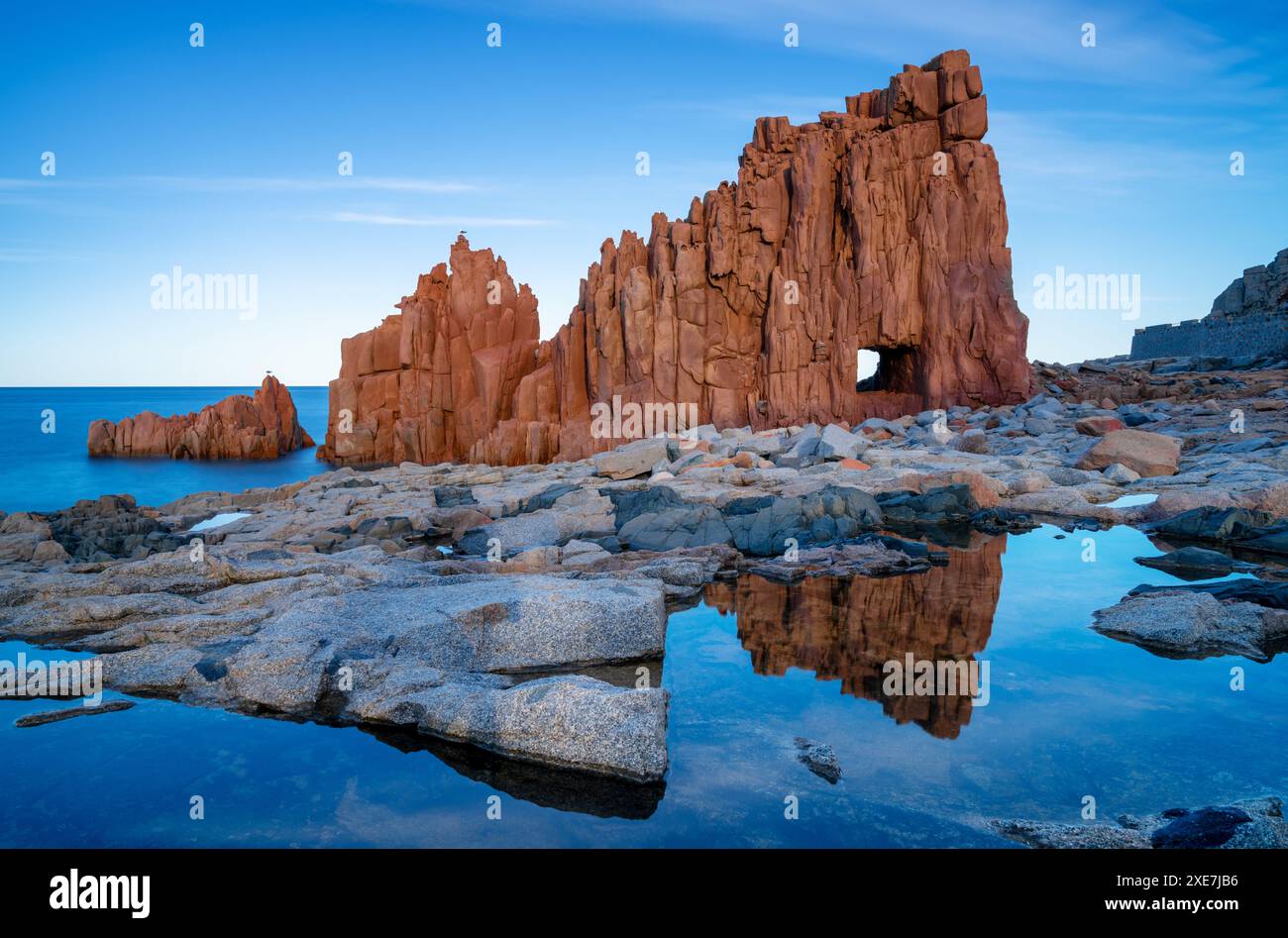 View of the red rocks of Arbatax with reflections in tidal pools in the ...