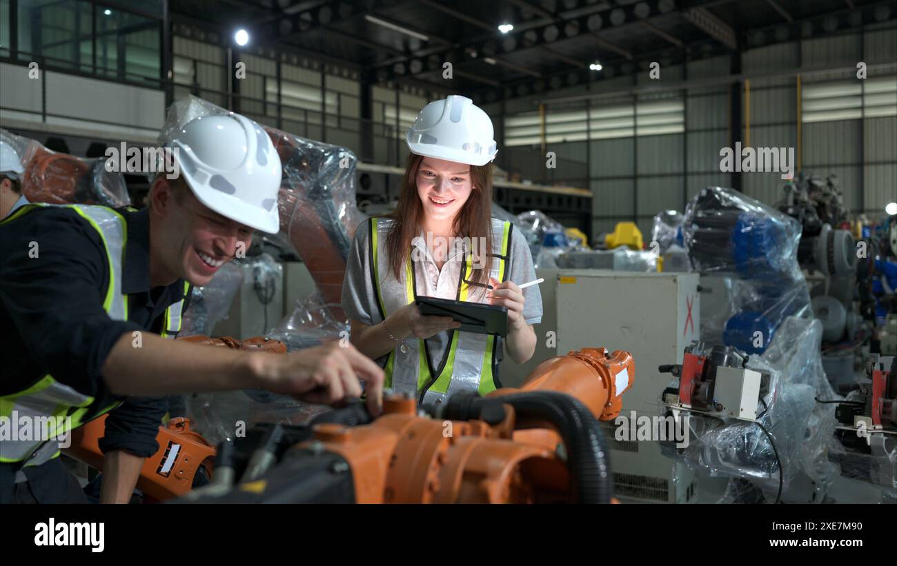 Both of engineers working together in a robotic arm factory, Robotic ...