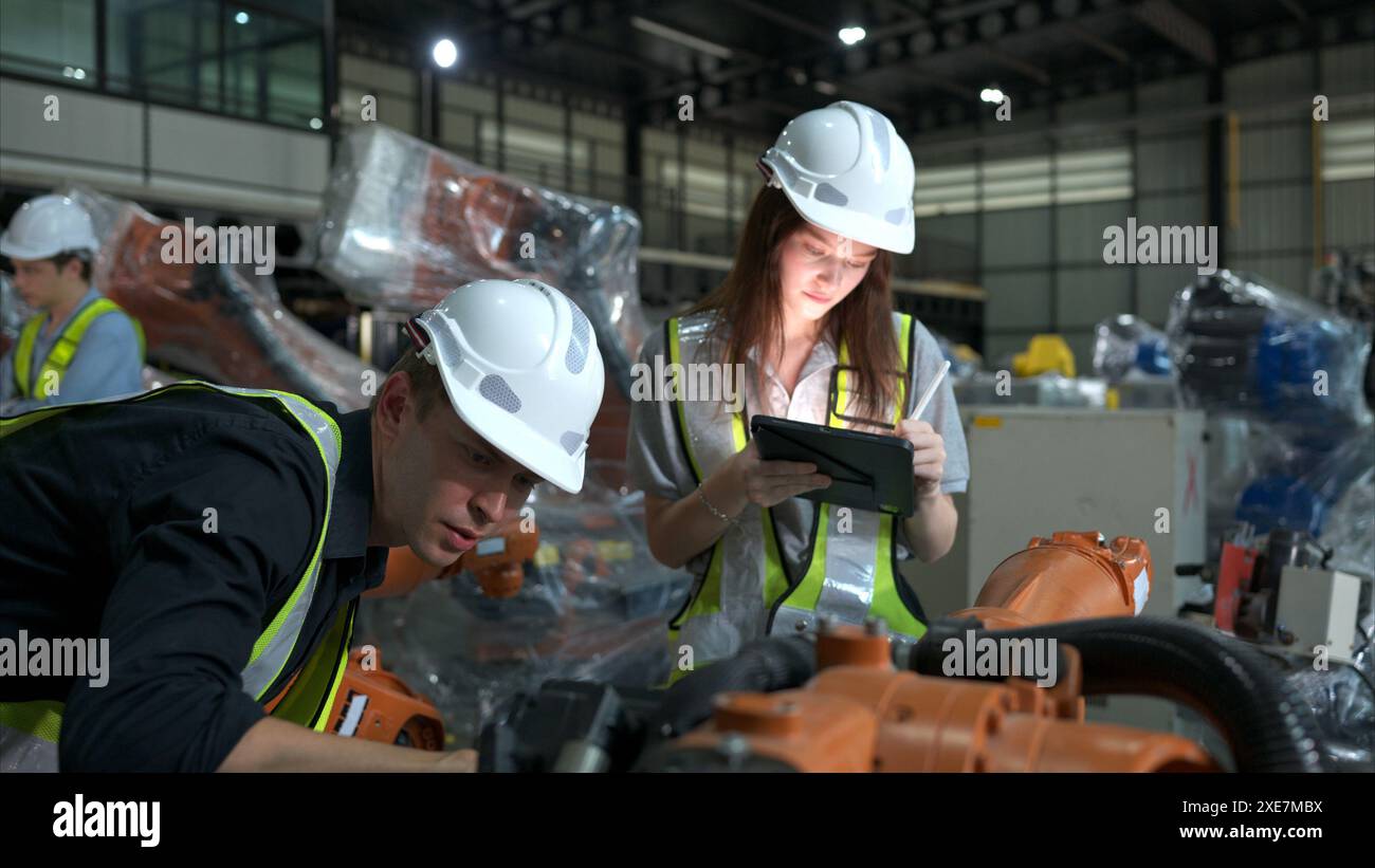Both of engineers working together in a robotic arm factory, Robotic ...