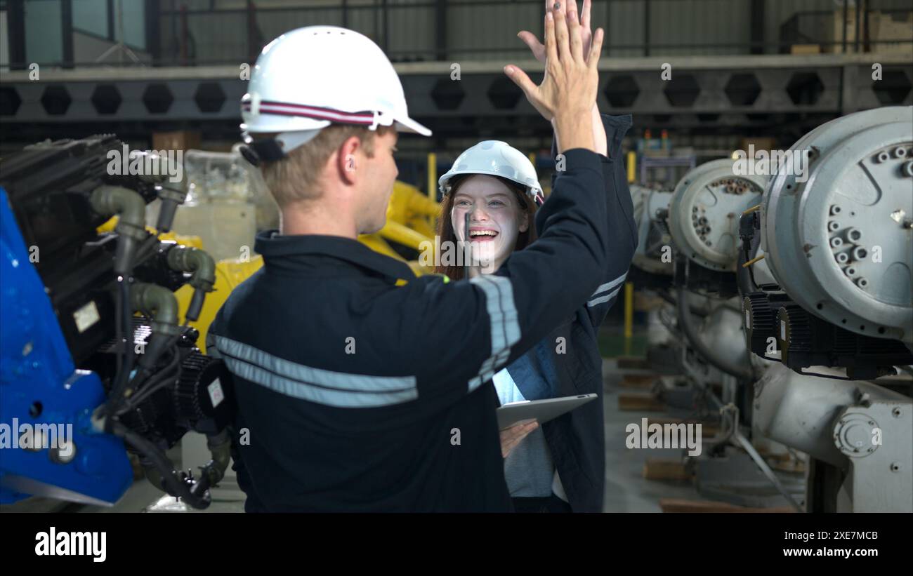 Both of engineers working together in a robotic arm factory, Robotic ...