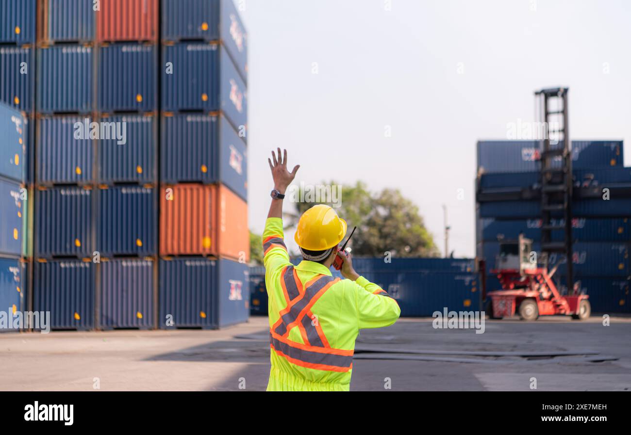 Workers in the import and export industry use walkie talkies to ...