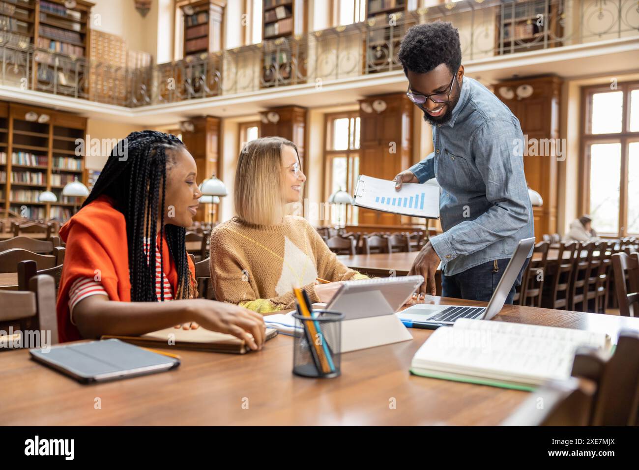 Group of international students working together in the library Stock ...