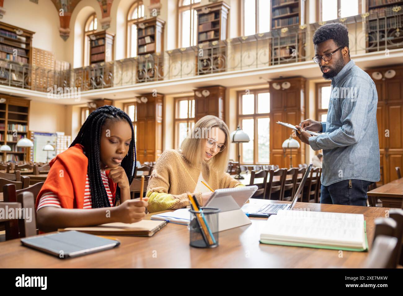 Group of international students working together in the library Stock Photo - Alamy