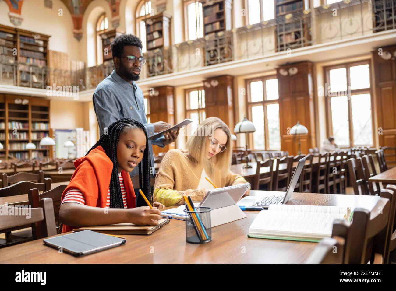 Group of international students working together in the library Stock ...