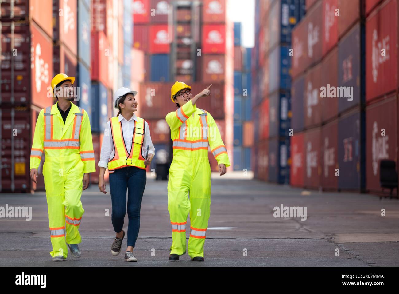Group of engineers working with laptop in the container yard. This is a ...