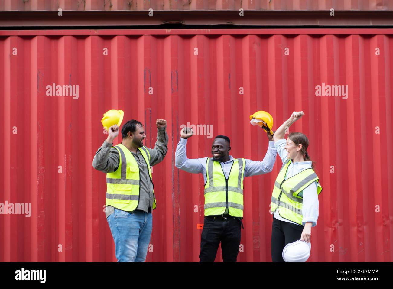 Group of workers in a container storage yard greeting each other during ...