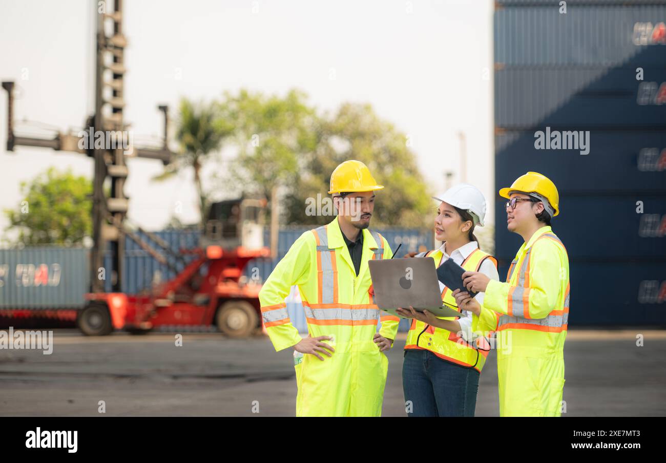Group of engineers working with laptop in the container yard. This is a ...